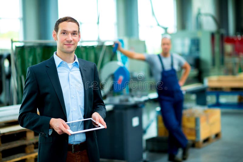 Young boss in his factory stock photo. Image of control - 56734790