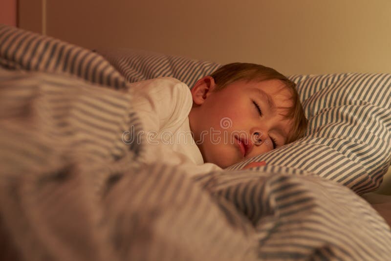Young Boy Asleep in Bed at Night Stock Photo - Image of years, asleep ...
