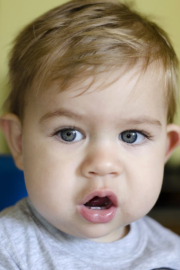 Young Boy with Beautiful Blue Eyes, Dubious Look Stock Image - Image of ...