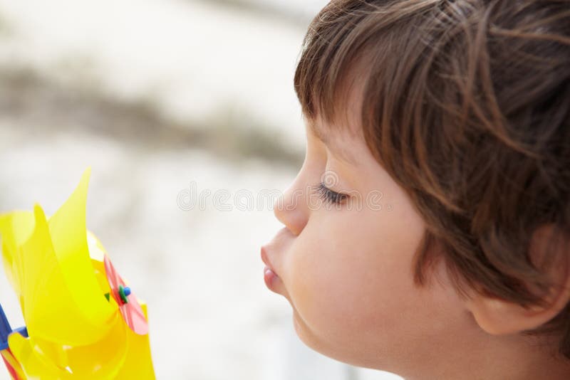Young Boy Blowing on Windmill Stock Photo - Image of play, playing ... Young Boy Blowing on Windmill Stock Photo - Image of play, playing ...