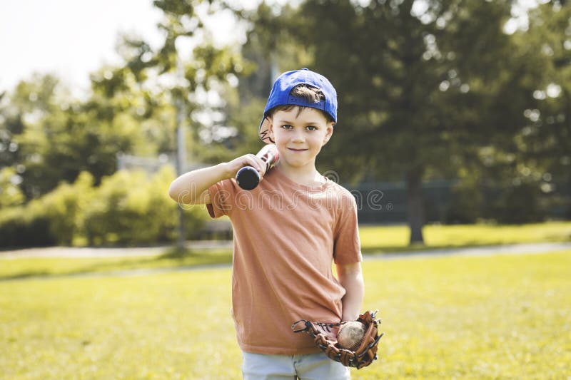 Young Boy with Blue Baseball Cap on a Field Stock Photo - Image of face ...