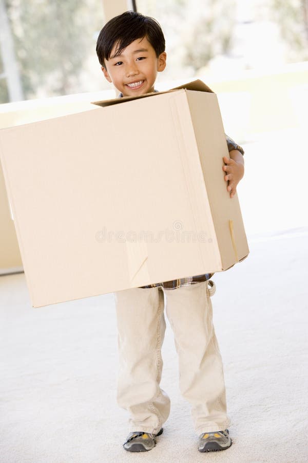 Young Boy with Box in New Home Smiling Stock Photo - Image of cardboard ...