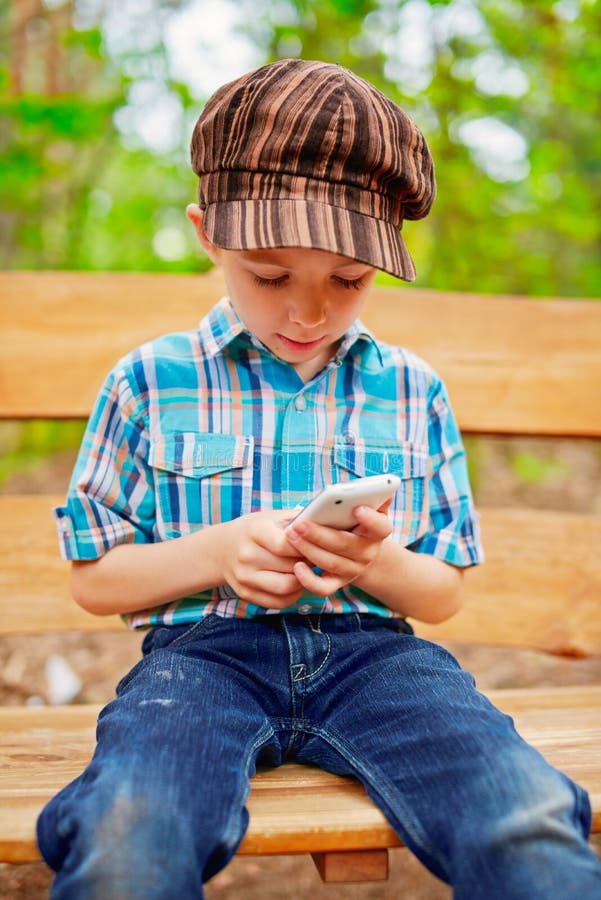 Young Boy Browsing Mobile Internet on Phone Stock Photo - Image of ...