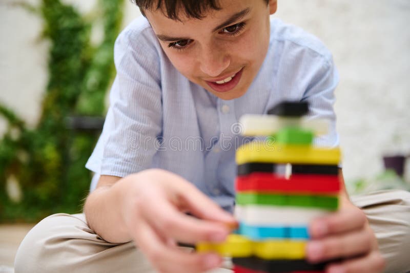 Young Boy Building Colorful Tower with Toy Blocks in Outdoor Setting ...