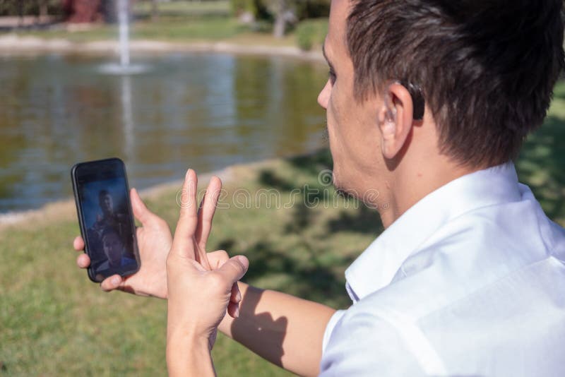 Young Boy Communicating with Sign Language at Smart Phone Stock Photo ...