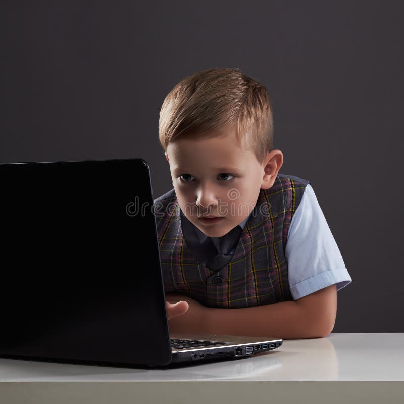 Young Boy with Computer. Funny Child Looking in Notebook Stock Image ...