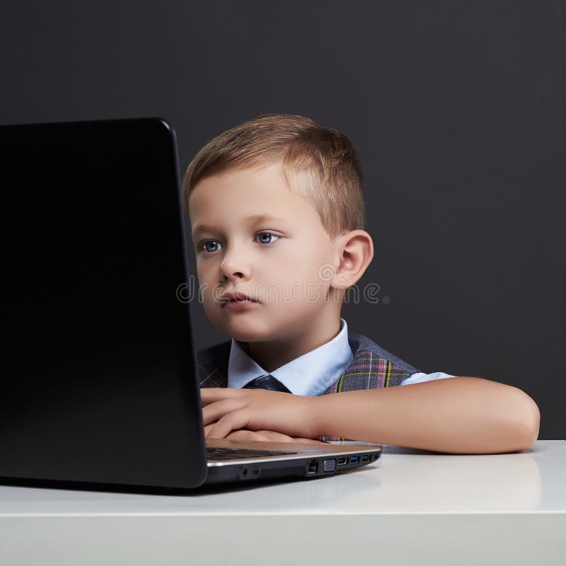 Young Boy with Computer. Funny Child Looking in Notebook Stock Photo ...