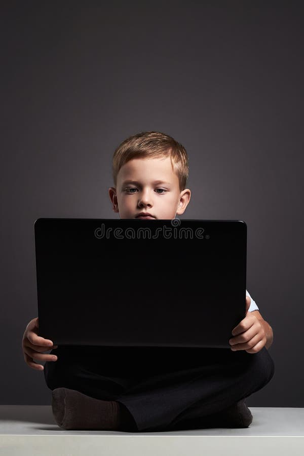 Young Boy with Computer. Funny Child Looking in Notebook Stock Image ...