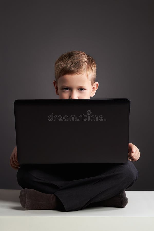 Young Boy with Computer. Funny Child Looking in Notebook Stock Photo ...
