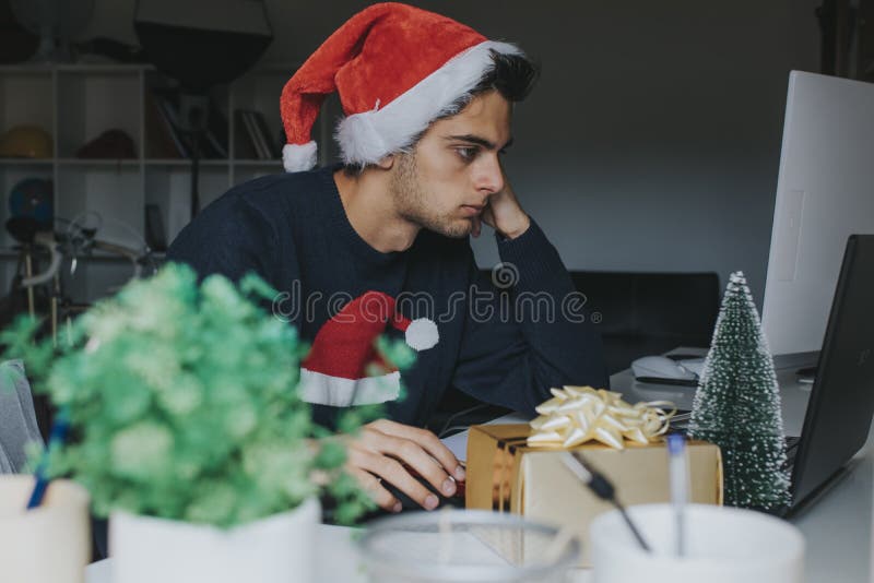 Young Boy on Computer Wearing Santa Hat Stock Photo - Image of teenager ...