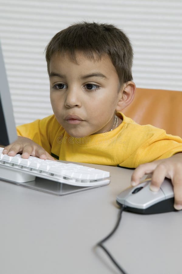Young Boy at Desk Using Computer Close Up Stock Image - Image of ...