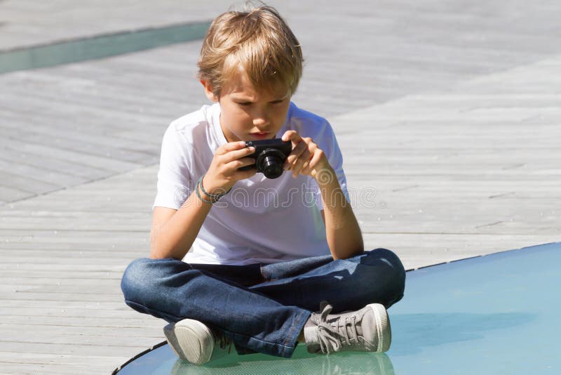 Young Boy with a Digital Camera Taking Pictures Outdoors Stock Photo ...