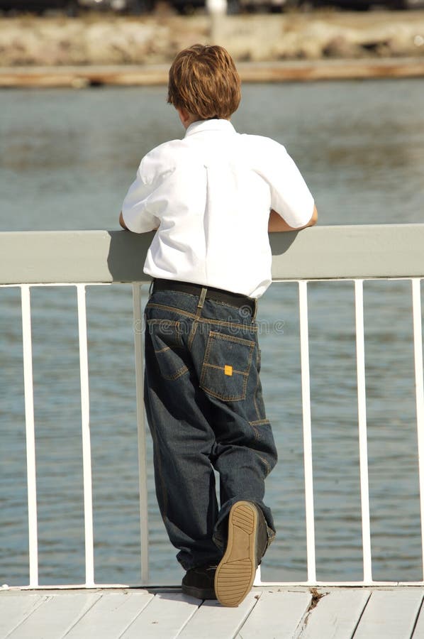 Young Boy on a Dock stock photo. Image of childish, forlorn - 1521140