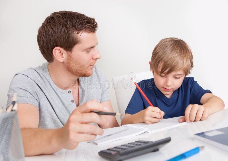 Man Helping Young Boy in Kitchen Doing Homework an Stock Photo - Image ...