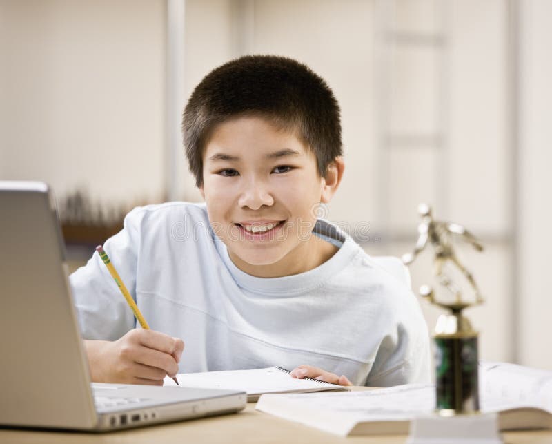 Young boy doing homework stock image. Image of internet - 5399695