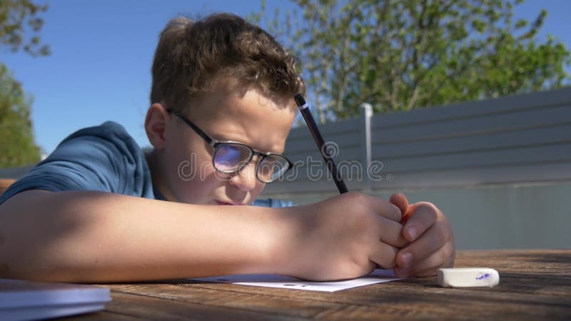 Young Boy Doing Homework, Outdoor Stock Video - Video of table ...