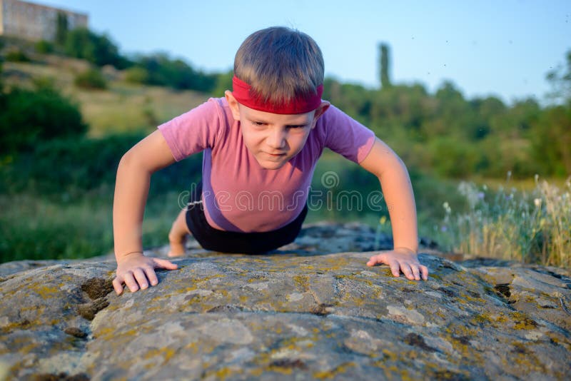 Young Boy Doing Push-ups on a Rock Stock Photo - Image of lifestyle ...