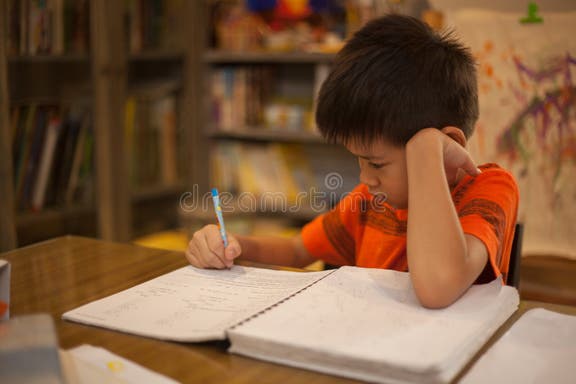 Young Boy Doing School Work Stock Photo - Image of answer, difficult ...