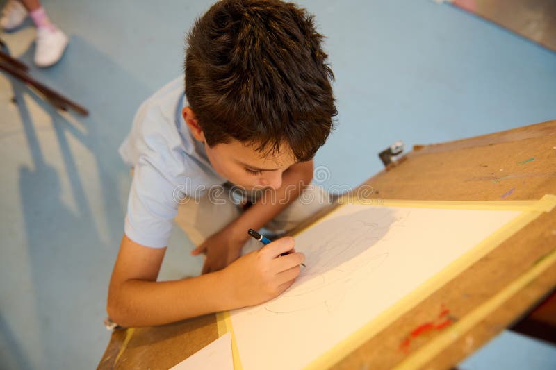 Young Boy Drawing at Art Class Workshop and Focused on Sketching Stock ...