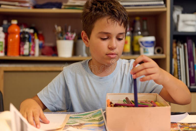 Young Boy Drawing with Colored Pencils in Art Class Workshop Stock ...