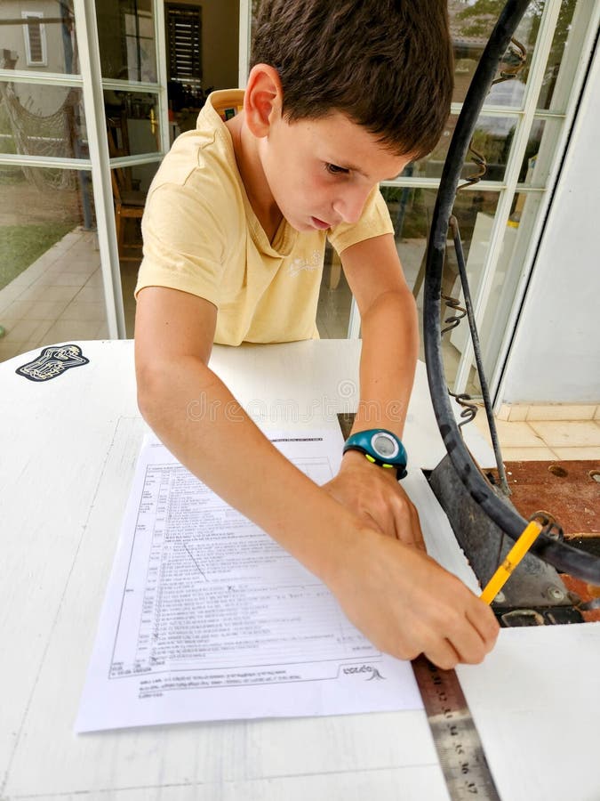 Young Boy Drawing on a Piece of Paper with a Pencil at Home Stock Photo ...