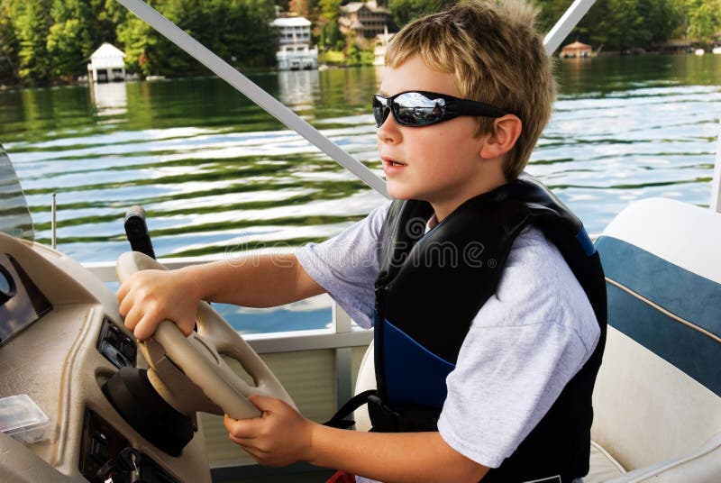 Young Boy driving a boat stock image. Image of beautiful - 4205803