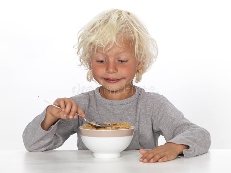 Young boy eating breakfast stock image. Image of cheeky - 10574013