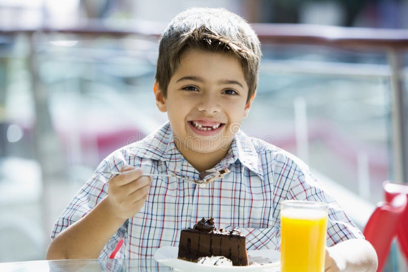 Young Boy Eating Chocolate Cake in Cafe Stock Image - Image of glass ...