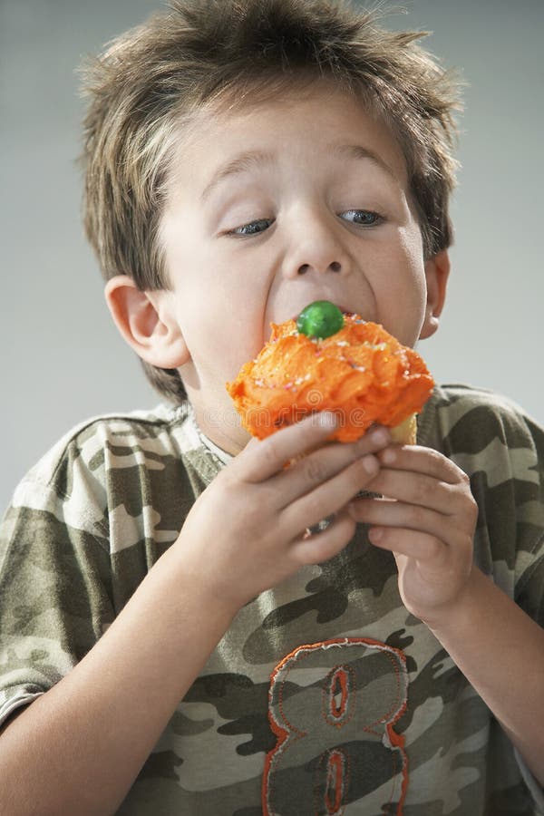 Young Boy Eating Cupcake at Birthday Party Stock Photo - Image of ...
