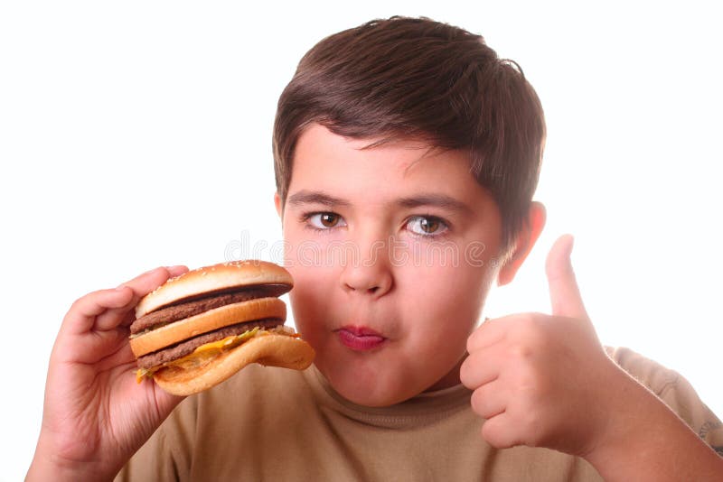 Young boy eating hamburger stock photo. Image of happy - 8692372