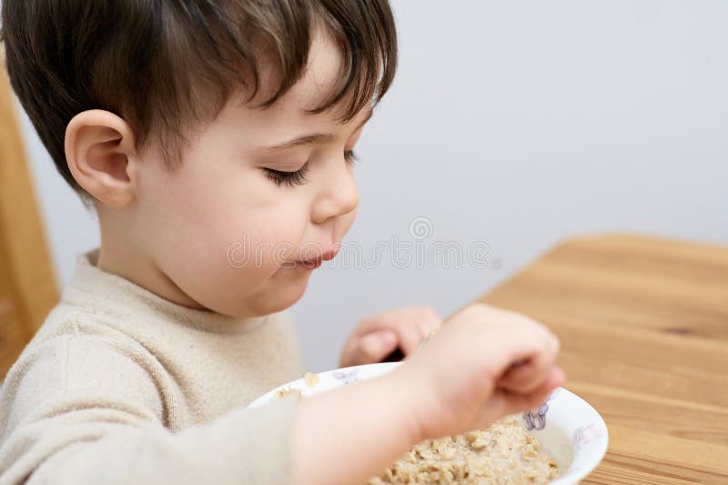 Young Boy Eating Oatmeal for Breakfast Stock Photo - Image of family ...