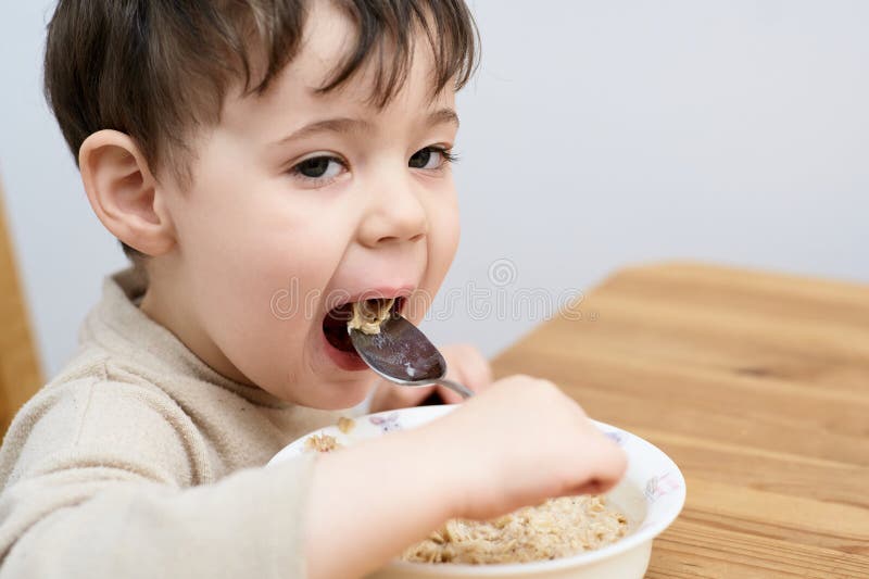 Young Boy Eating Oatmeal for Breakfast Stock Photo - Image of adorable ...