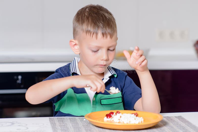Young Boy Eating Plate of Cheese and Fruit Stock Photo - Image of ...