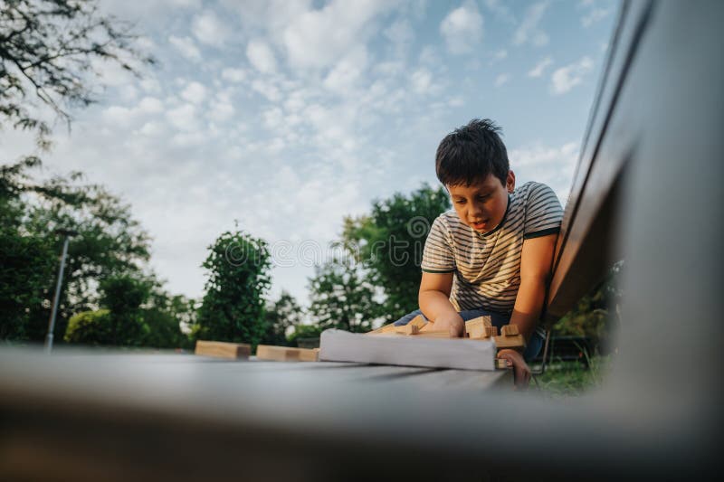 Young Boy Enjoying Building Blocks Game Park Outdoors Stock Photos ...