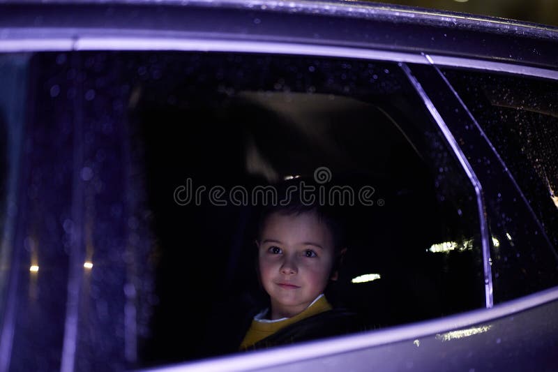 A Young Boy Enjoys a Car Ride, Captured through the Window, As he ...