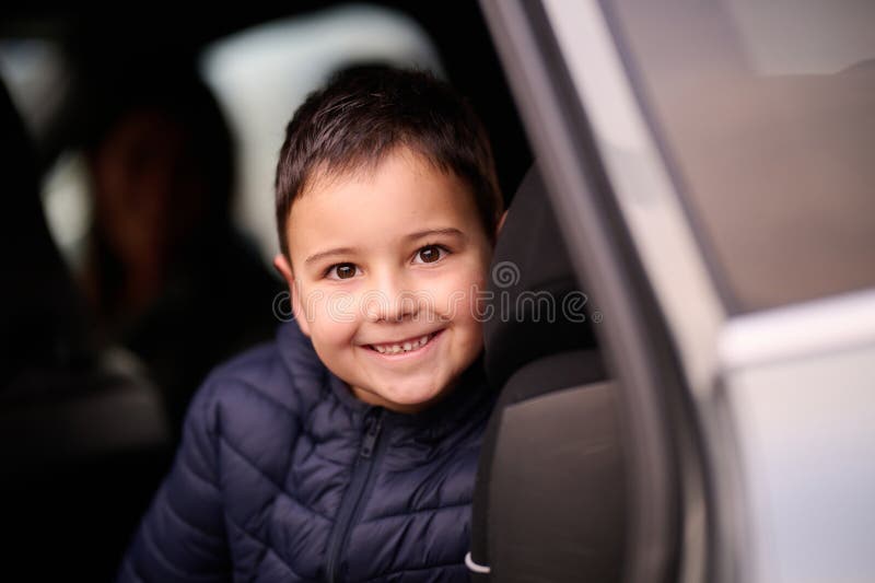 A Young Boy Enjoys a Car Ride, Captured through the Window, As he ...