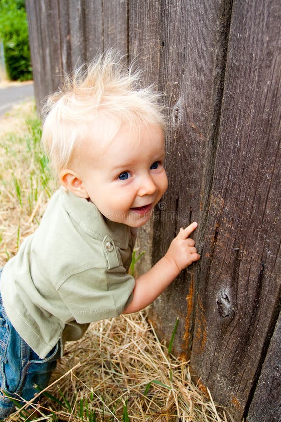 Young Boy by Fence stock photo. Image of outside, years - 15512196
