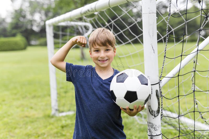 Young Boy with Football on a Field Having Fun Stock Image - Image of ...