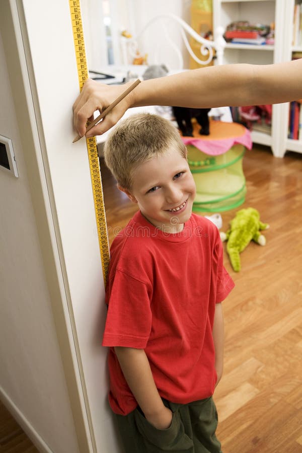 Young Child Measuring Height on Growth Chart Stock Photo - Image of ...