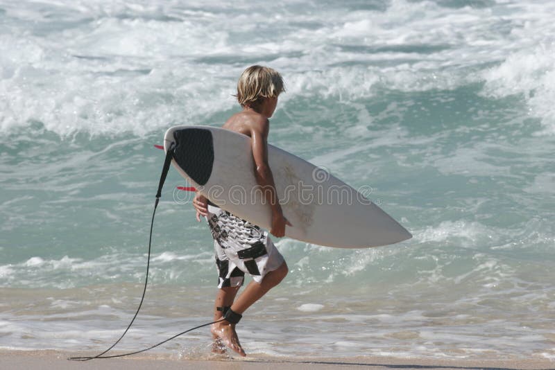 Young Boy Going Surfing stock photo. Image of shoreline - 1099564