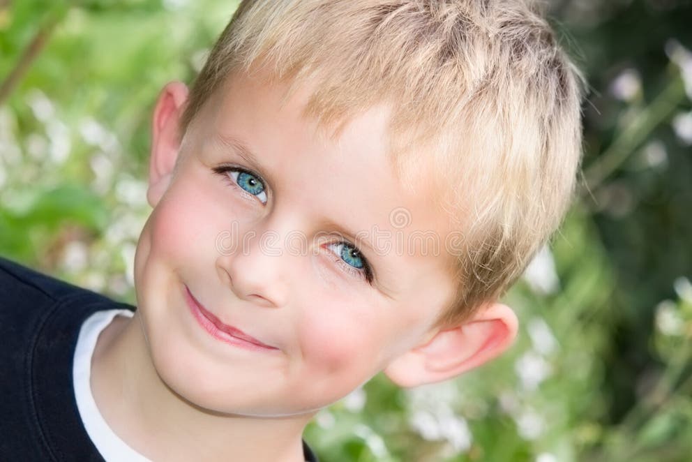 Young Boy Grinning in the Garden Stock Photo - Image of white, flowers ...