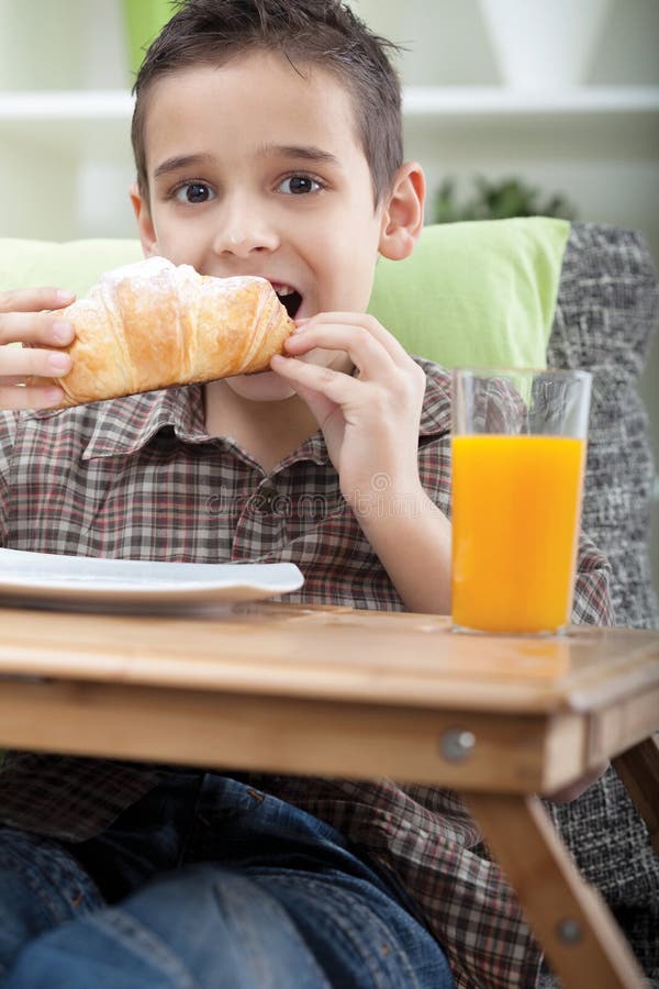 Young boy having breakfast stock photo. Image of people - 37053810