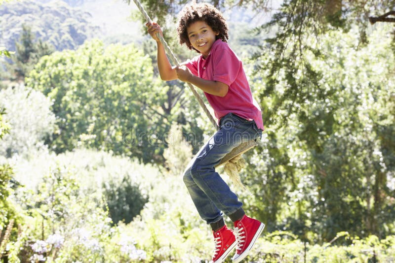 Young Boy Having Fun on Rope Swing Stock Photo - Image of people ...