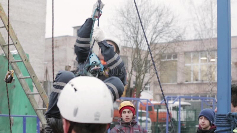 Young Boy in Helmet, Rescue Uniform Get Up on Ropes. Emercom Practice ...