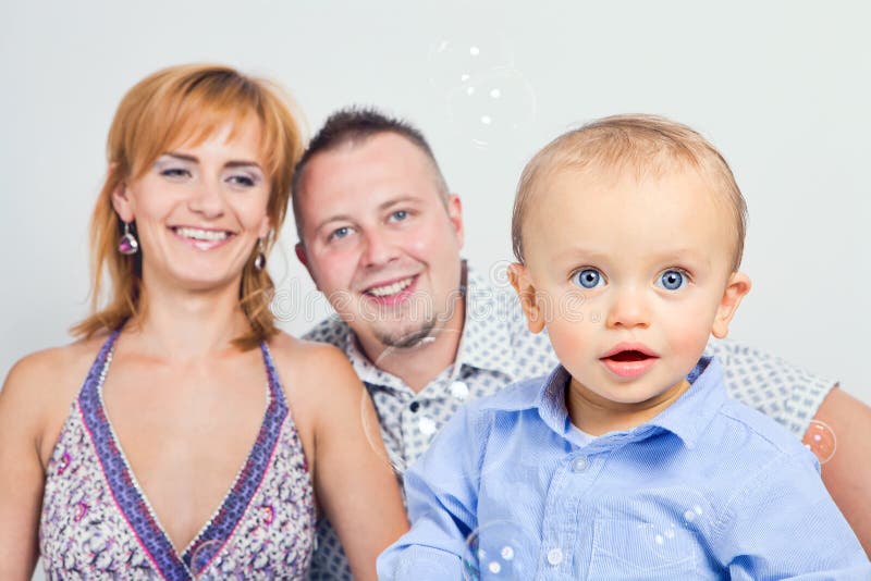 Young boy with parents stock image. Image of mother, laughing - 22306697
