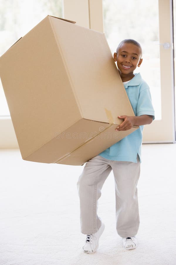 Young Boy Holding Box in New Home Smiling Stock Photo - Image of happy ...