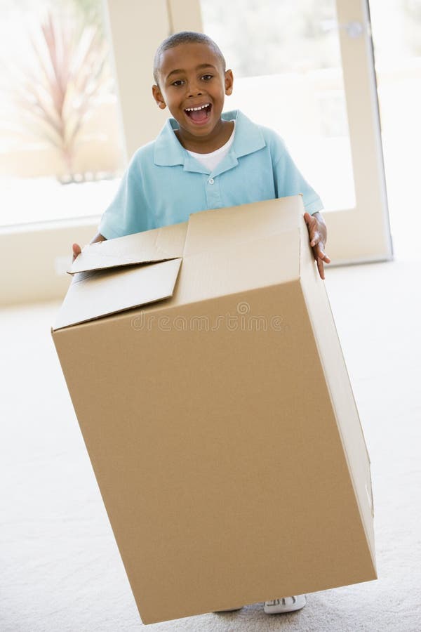 Young Boy Holding Box in New Home Smiling Stock Photo - Image of happy ...