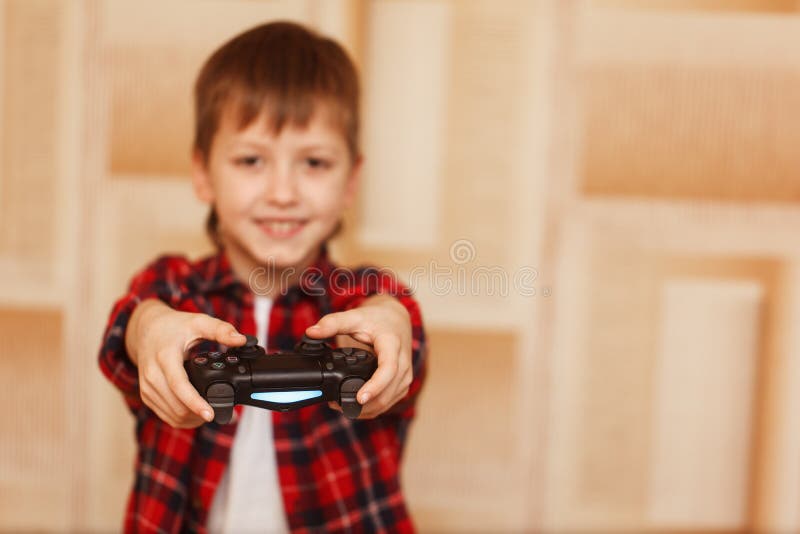 Boy Holding Joystick and Playing Video Game, Resting at Home. Focus on ...