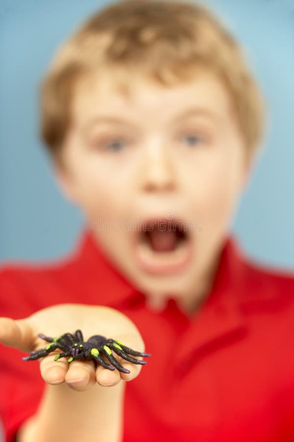 Young Boy Holding Plastic Spider Stock Image - Image of child, spider ...