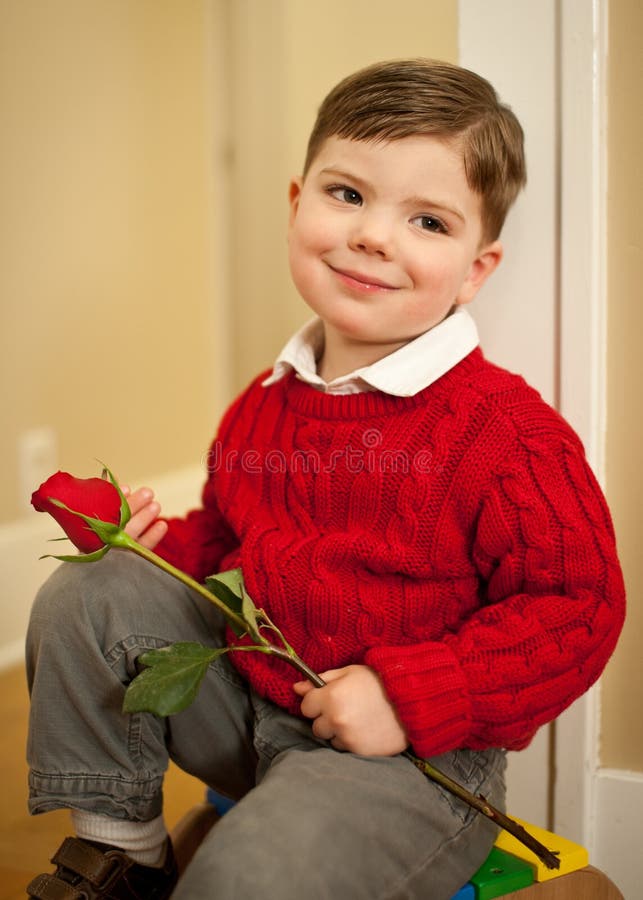 Young boy holding red rose stock photo. Image of portrait - 14915058